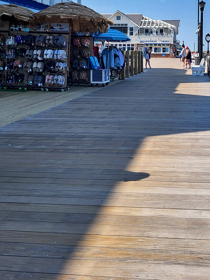 Beach essentials on display&mdash;flip-flops hanging like tropical fruit, ready to be plucked by barefoot visitors seeking relief from hot boardwalk planks.