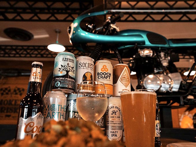 The craft beer selection proves these folks understand that great barbecue deserves equally thoughtful beverages. That vintage motorcycle overhead? Just showing off.