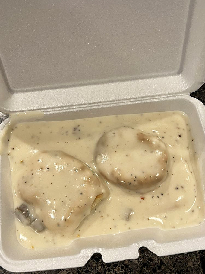 Biscuits swimming in gravy like they're enjoying a spa day. Southern comfort in styrofoam&mdash;practical, unpretentious, and perfect.