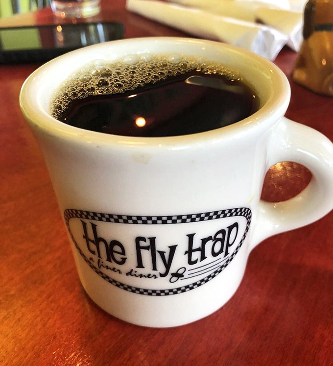 The coffee comes in a mug substantial enough to hug back. That checkered pattern says "diner," but the brew says "we actually care."