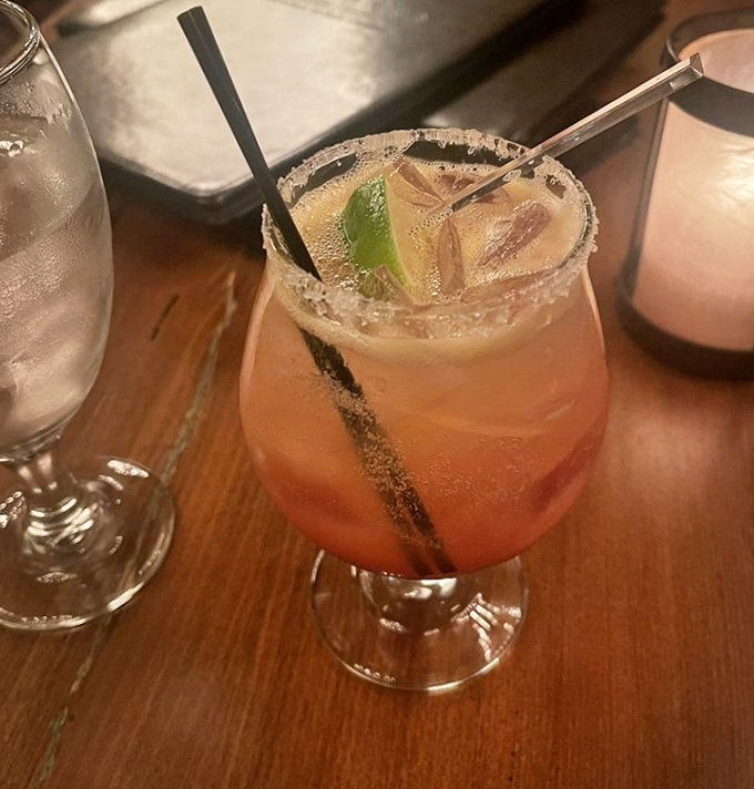 A cocktail that looks like sunset in a glass. This isn't just a drink—it's what happens when fruit and spirits decide to throw a party.