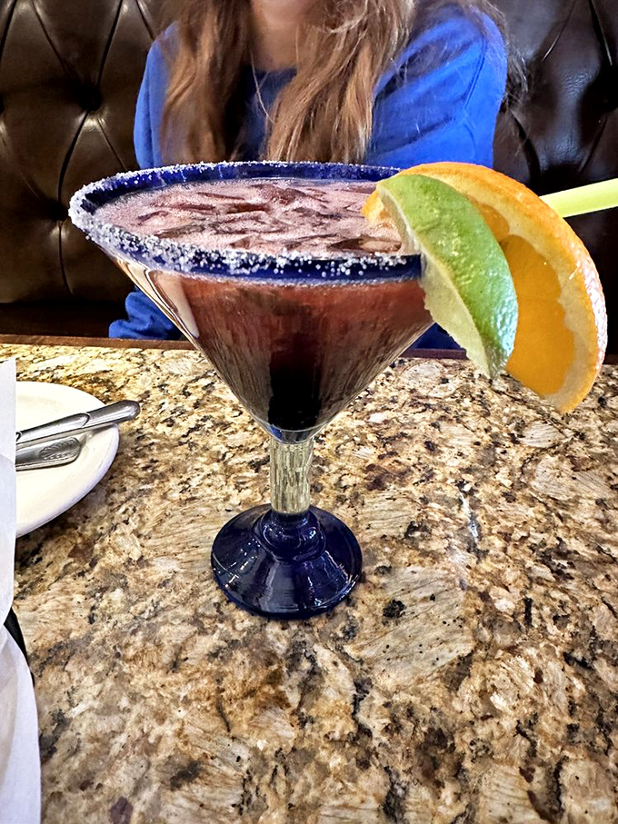 This isn't just a margarita&mdash;it's liquid jewelry. The salt-rimmed glass, vibrant color, and fresh garnishes promise a vacation in every sip.