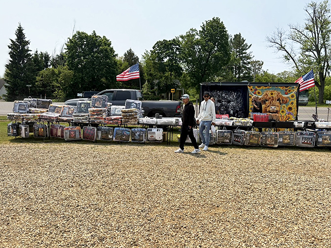 The blanket vendor who's seen it all. American flags wave proudly overhead as shoppers browse collections that would make any collector's heart race.