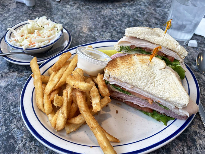 This club sandwich stands taller than some of Ohio's hills, with crispy fries that look like they're auditioning for a food commercial.