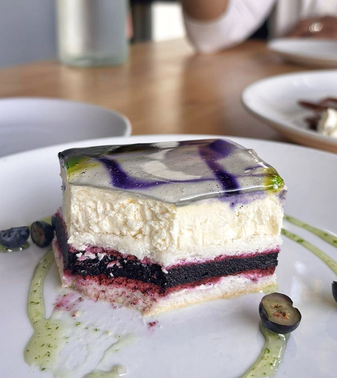 Dessert architecture at its finest&mdash;layers of berry-infused cake beneath a silky white topping, finished with an artistic gel that's almost too beautiful to eat. Almost.
