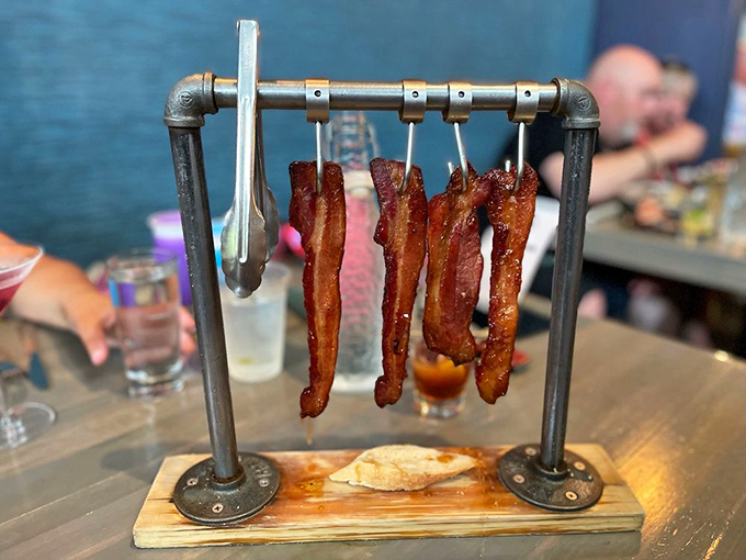 Bacon elevated to performance art. This isn't just breakfast's sidekick anymore&mdash;it's the main event, hanging like delicious curtains on an industrial stage.