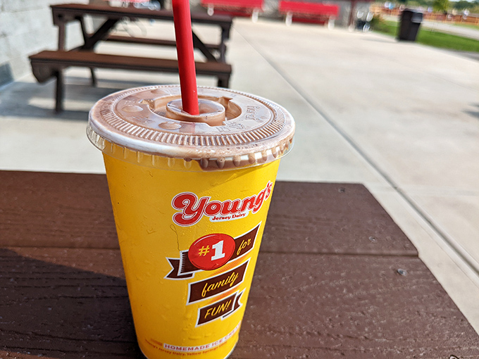 Young's signature yellow cup holds liquid happiness, a shake thick enough to make your straw stand at attention like a dairy soldier.