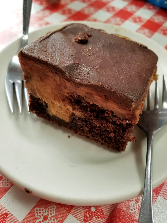 A slice of chocolate cake that doesn't need a fancy French name to be magnificent. Three distinct layers of chocolate bliss that demand to be savored slowly.
