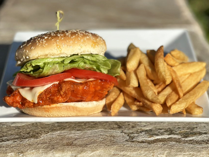 This buffalo chicken sandwich doesn't whisper spice&mdash;it announces it proudly. Crispy, saucy perfection with fresh lettuce, tomato and fries that refused to be upstaged.