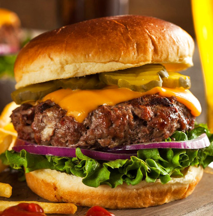 A burger that requires both hands and several napkins&mdash;the kind that makes you temporarily forget your table manners and embrace the beautiful mess.