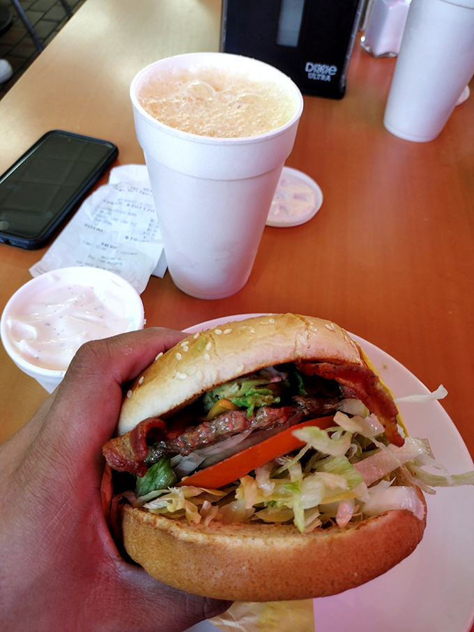 That milkshake isn't just a beverage&mdash;it's a commitment, standing tall beside a burger that's dressed for success with fresh lettuce and tomato.