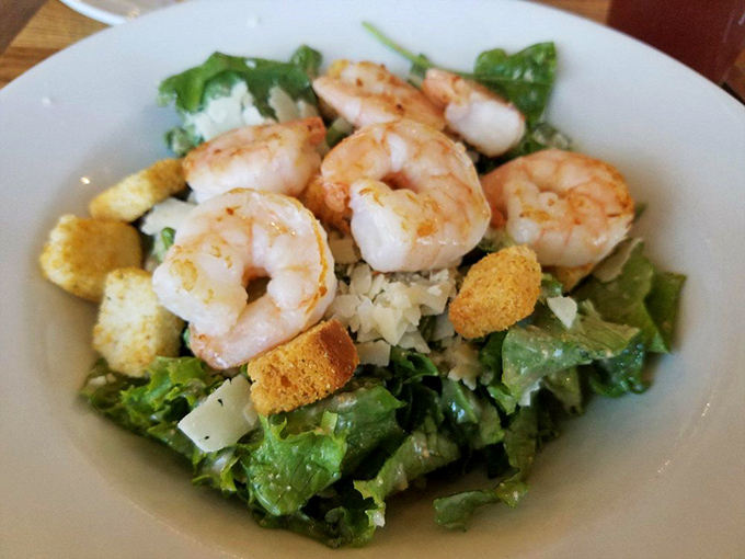 Caesar salad reimagined: perfectly grilled shrimp perched atop crisp romaine with golden croutons. Even salad skeptics will be reaching for forks.