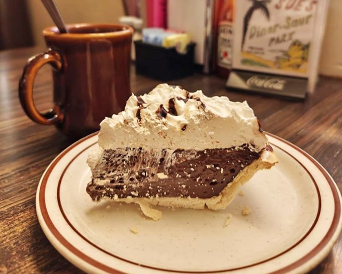 Chocolate cream pie with a mountain of whipped topping that makes you wonder why anyone ever invented fancy desserts when perfection already existed.