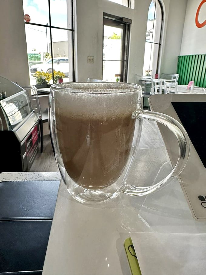 That's not just a cappuccino&mdash;it's liquid therapy in a double-walled glass, perfect for contemplating life's big questions, like "Should I order seconds?"
