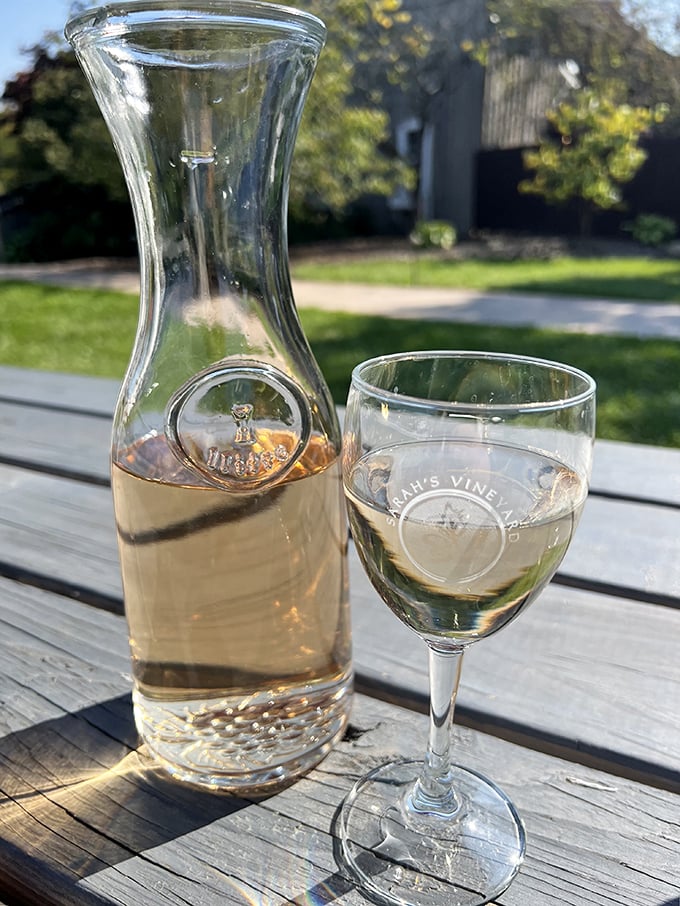 A carafe of crisp white wine catching the sunlight&mdash;nature's way of saying "it's definitely wine o'clock somewhere."
