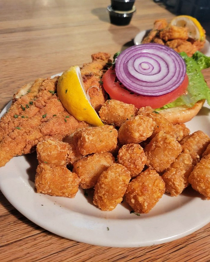 This catfish sandwich with its golden crust and fresh toppings isn't just lunch&mdash;it's what happens when a fishing story ends with "and then we ate well."