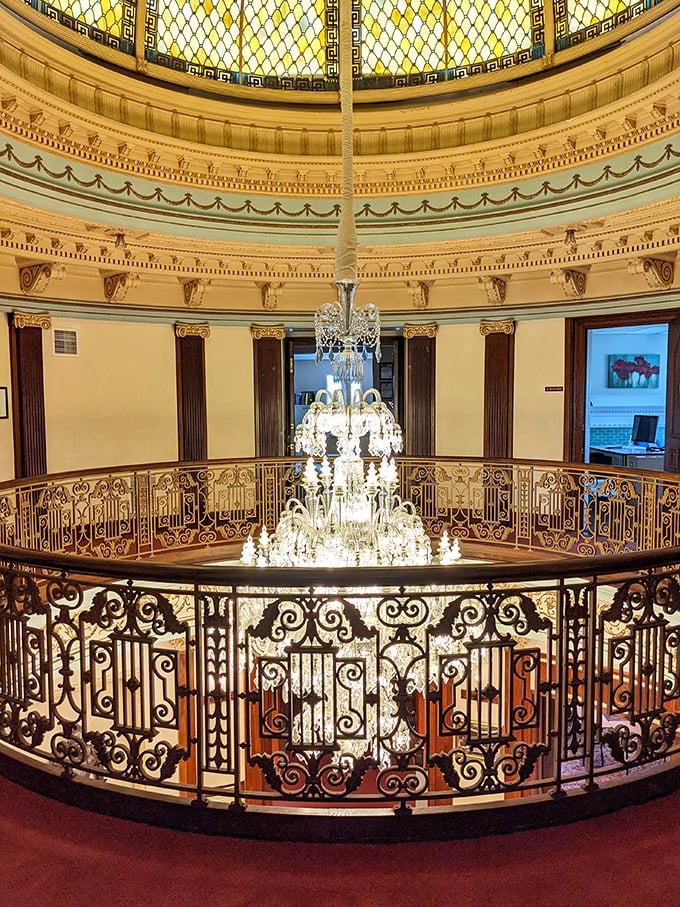 The rotunda's chandelier and intricate ironwork create a dizzying display of craftsmanship that has visitors craning their necks in wonder.
