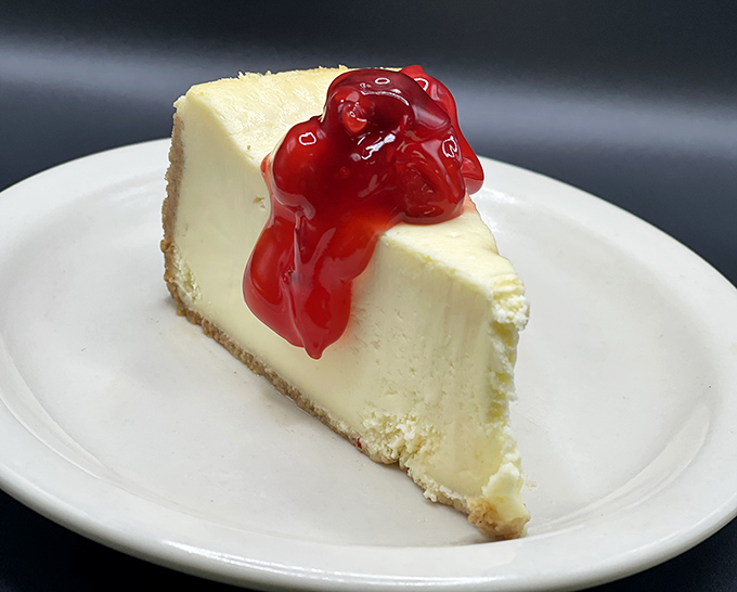A slice of cheesecake topped with cherry compote that makes you wonder why you ever considered skipping dessert.