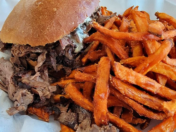 Sweet potato fries that could make a grown adult giggle with delight. Crispy, orange-hued treasures flanking a sandwich that's practically begging to be devoured.