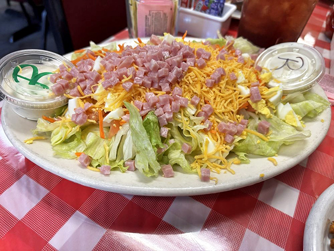 This chef salad isn't just playing dress-up with lettuce—it's a colorful celebration topped with perfectly diced ham and shredded cheese that means business.