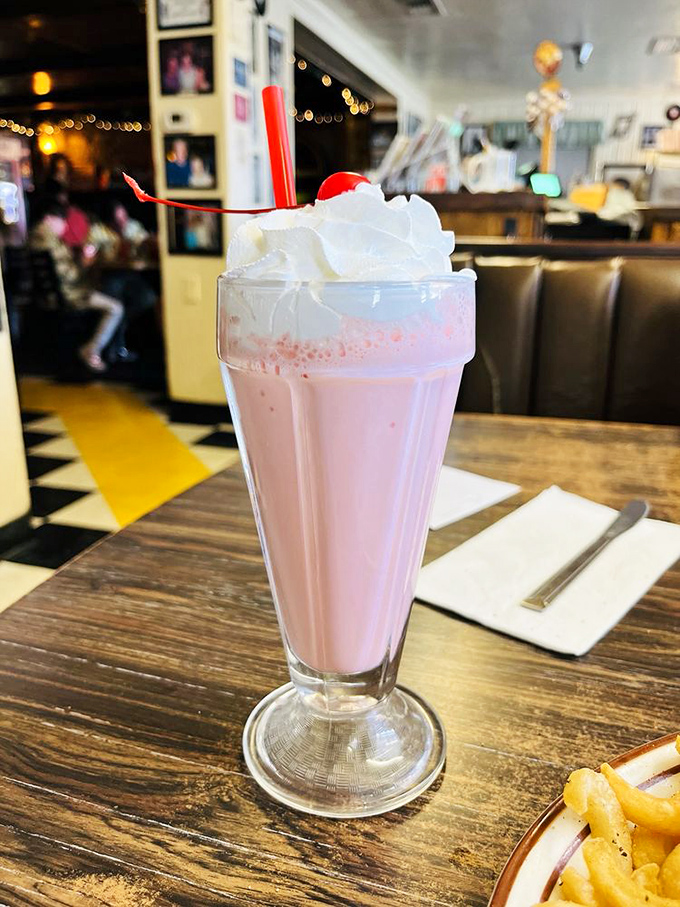 A strawberry milkshake topped with enough whipped cream to make your inner child high-five your adult self for making excellent life choices.
