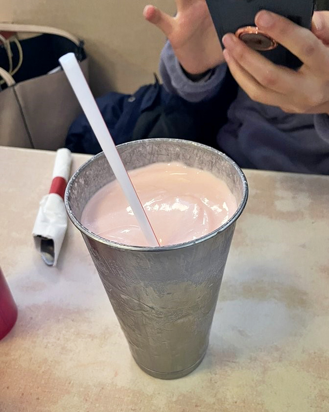 The milkshake so thick it defies gravity. Strawberry happiness in a metal cup that makes you wonder why anyone bothered inventing fancy desserts.