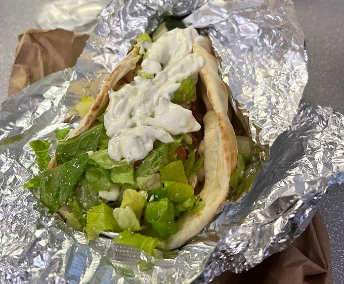 Fresh veggies nestled in a pita with creamy sauce&mdash;proof that not all heroes wear capes, some come wrapped in foil.