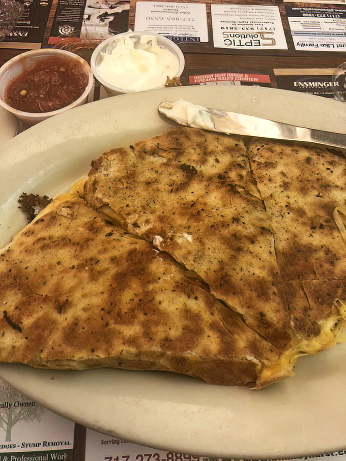 The quesadilla arrives looking like it's been working out—buff with cheese, seasoned to perfection, and flanked by sides that aren't just afterthoughts.