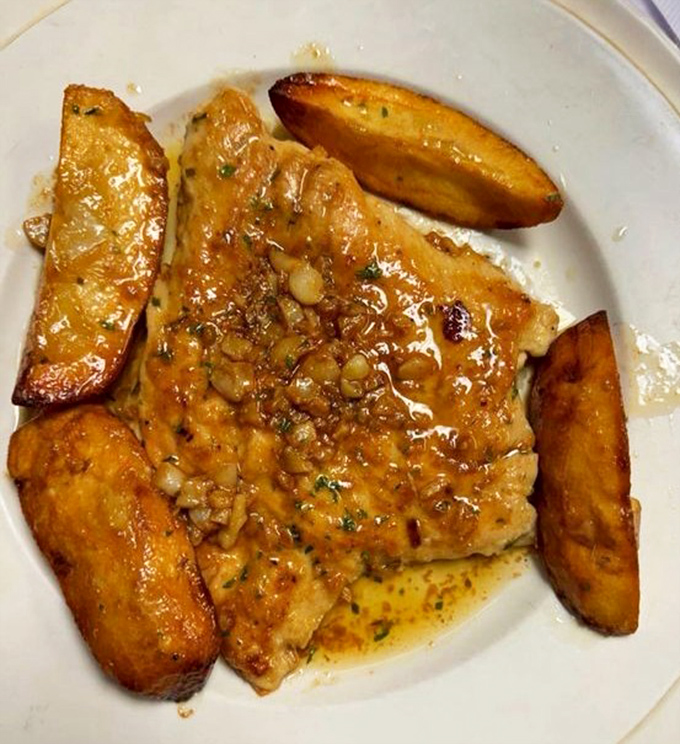 Chicken that's been kissed by garlic and herbs, surrounded by potatoes that have achieved golden-brown enlightenment. Dinner doesn't get more satisfying.