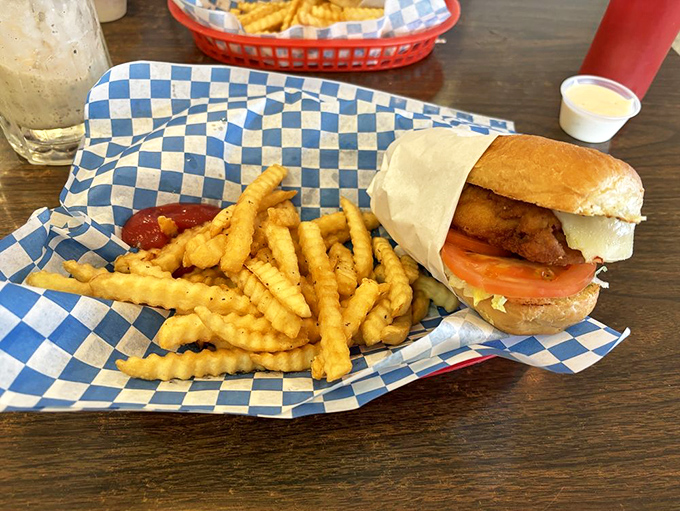 The chicken sandwich sits in its checkered paper boat like it owns the place. And with fries this golden, who could argue?