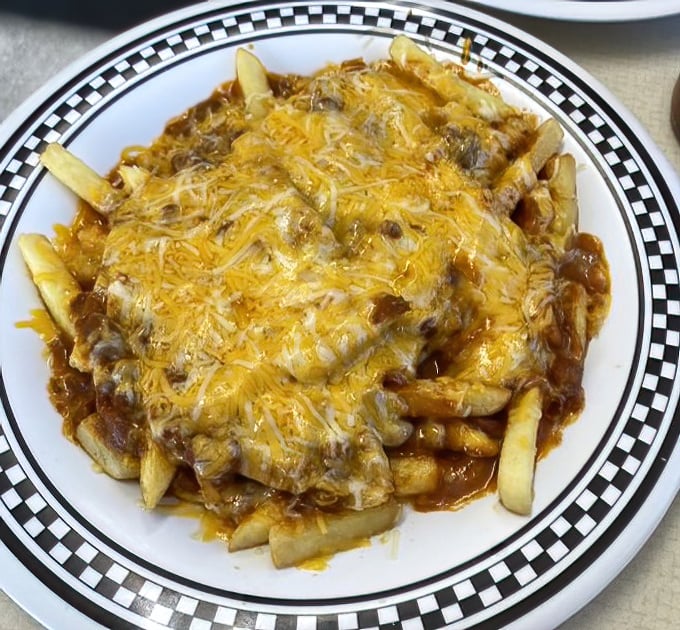 These chili cheese fries aren't just a side &ndash; they're a main event covered in a blanket of melted cheese that stretches with each magnificent bite.