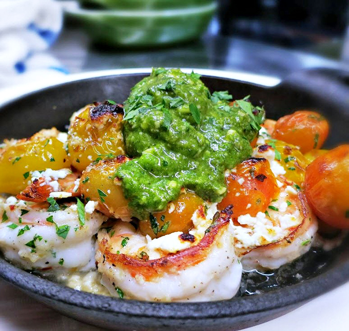 Plump prawns dancing with colorful heirloom tomatoes and that vibrant green sauce&mdash;a California seafood love story on a plate.