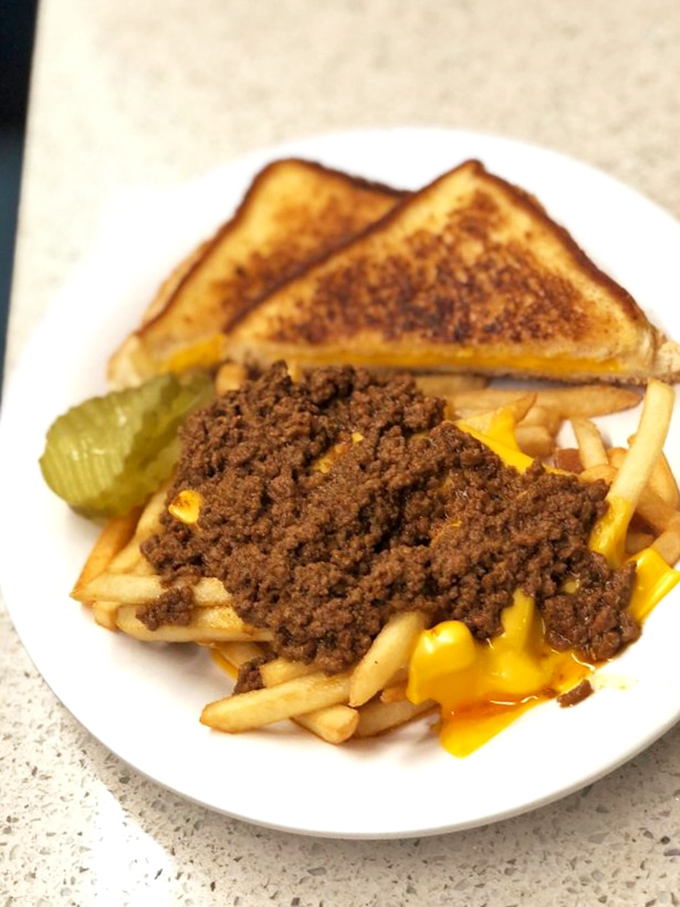 Chili cheese fries: where comfort food meets artistic expression, with melted cheese creating golden rivers through mountains of savory beef.