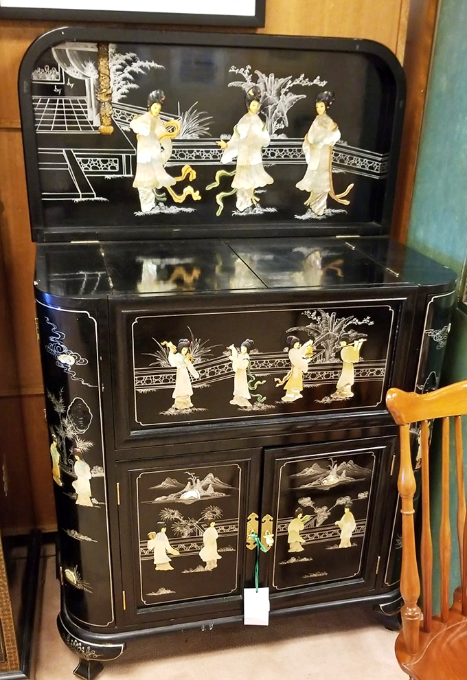 Asian-inspired elegance with inlaid mother-of-pearl figures. This cabinet would make even your mismatched tupperware look sophisticated.