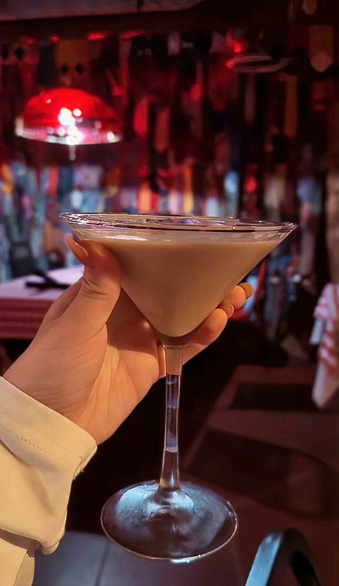 A perfectly mixed martini catching the warm glow of the bar lights&mdash;liquid velvet that makes waiting for your steak a pleasure, not a chore.