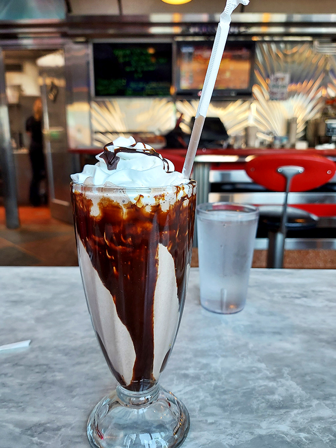 This chocolate milkshake isn't just a drink, it's a commitment&mdash;with whipped cream architecture that belongs in a museum of delicious decisions.