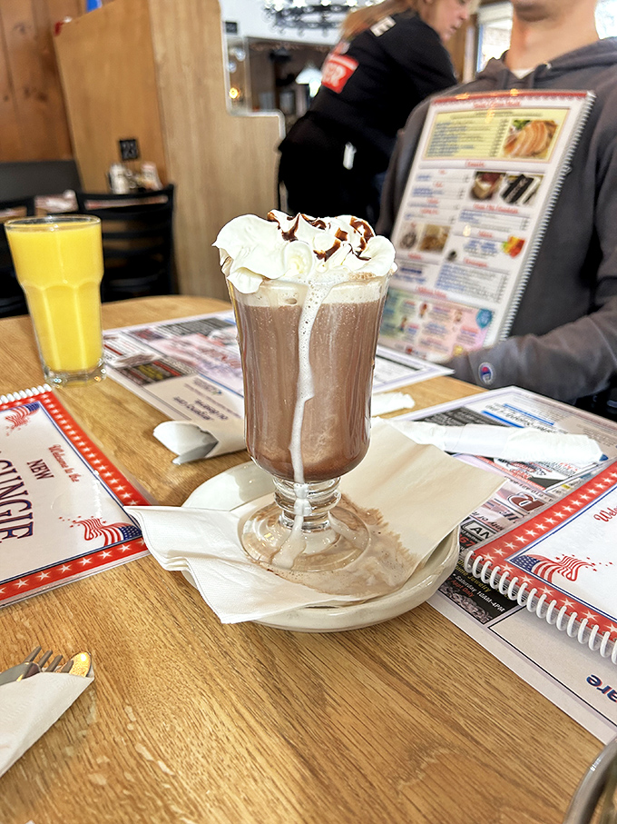 This isn't just a chocolate milkshake – it's a tower of whipped cream magnificence that demands both a spoon and straw strategy.
