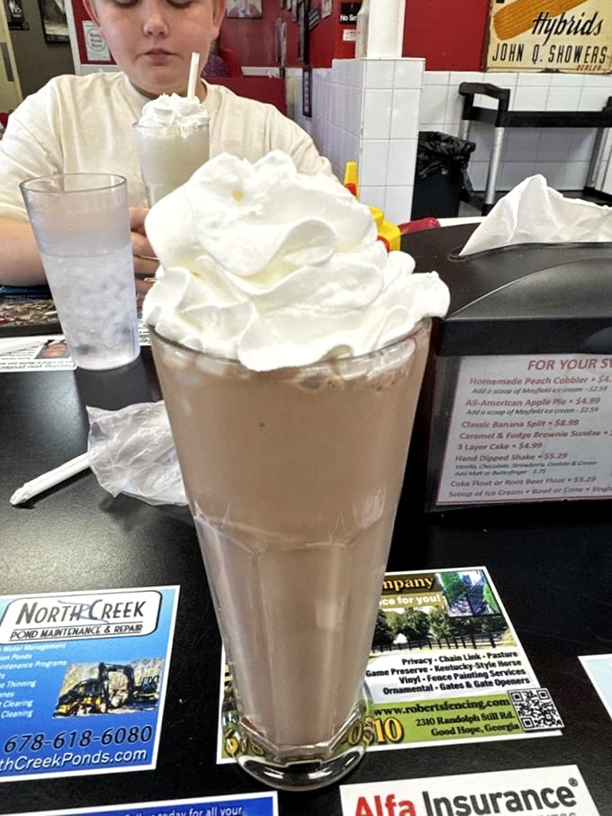 This chocolate shake isn't just tall&mdash;it's skyscraper-ambitious, with a cloud of whipped cream that makes you wonder if you should drink it or frame it.