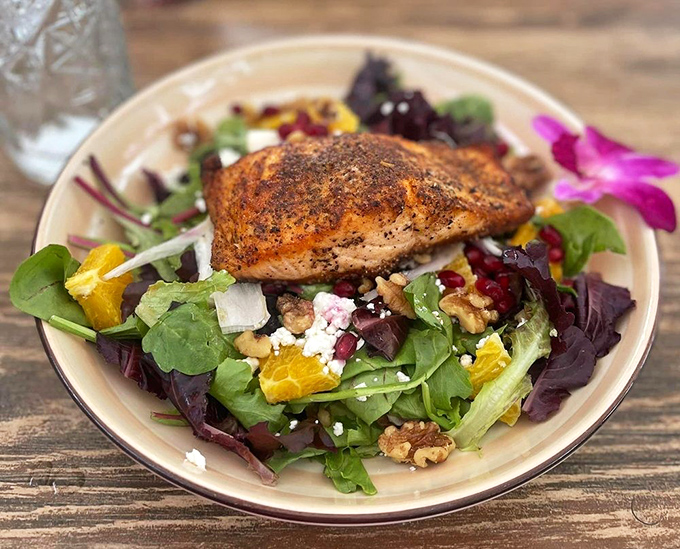 A vibrant salad topped with blackened salmon that proves healthy eating doesn't have to feel like punishment.