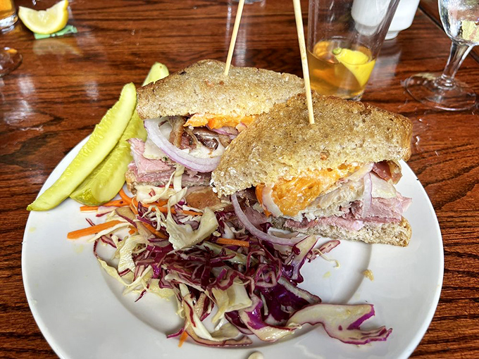 This isn't just a sandwich; it's an architectural marvel of layers, textures, and colors that somehow fits between two slices of bread.