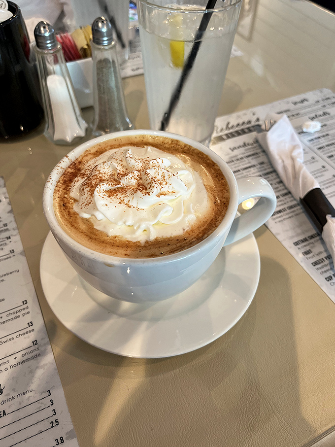 Coffee this good doesn't need a passport to transport you. The whipped cream mountain on top is just the dreamy bonus.