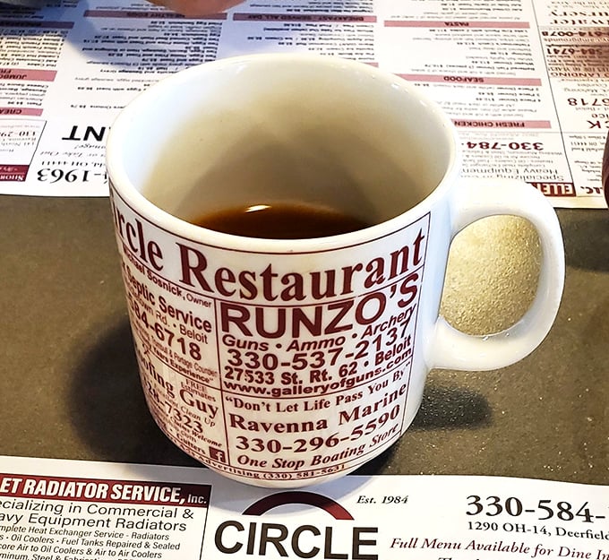 The coffee mug doubles as local advertising real estate&mdash;because in small-town Ohio, your caffeine fix comes with community connections.