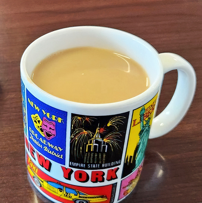 Coffee served in a souvenir mug, because regular cups can't contain the diner magic. This isn't just caffeine&mdash;it's liquid motivation.