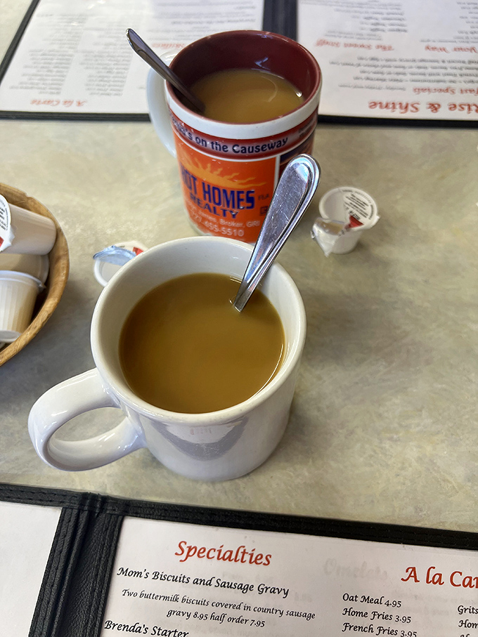Coffee strong enough to wake the dead, served in mugs that have witnessed countless breakfast conversations and life stories.