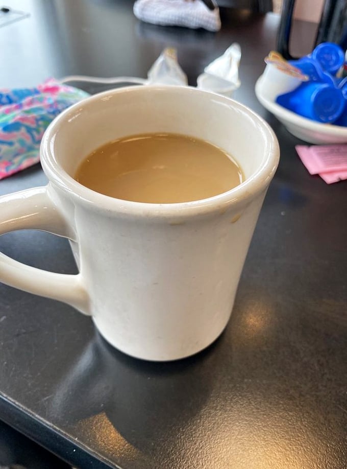 That classic white diner mug isn't just holding coffee&mdash;it's cradling liquid motivation in ceramic form. The unofficial mascot of morning people everywhere.