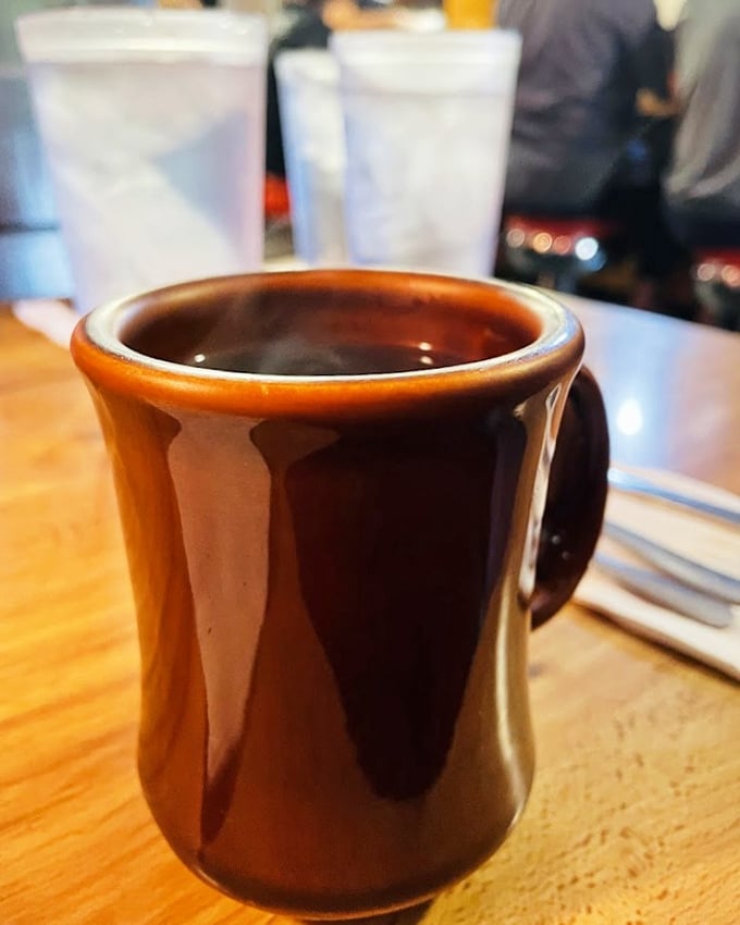 That brown mug contains liquid motivation, not just coffee. The kind that makes Monday mornings slightly less criminal.