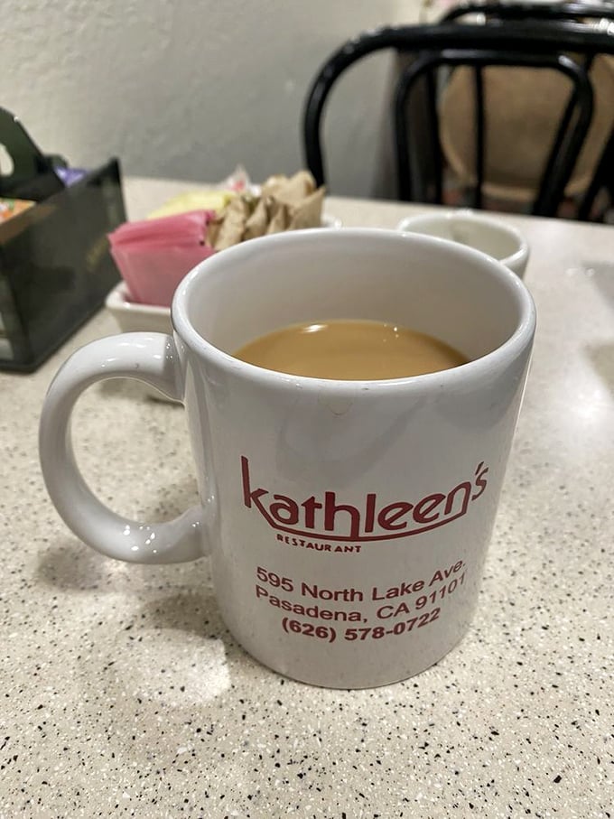 The official morning kickstart&mdash;Kathleen's branded mug promises the caffeinated courage needed to face whatever Monday throws your way.