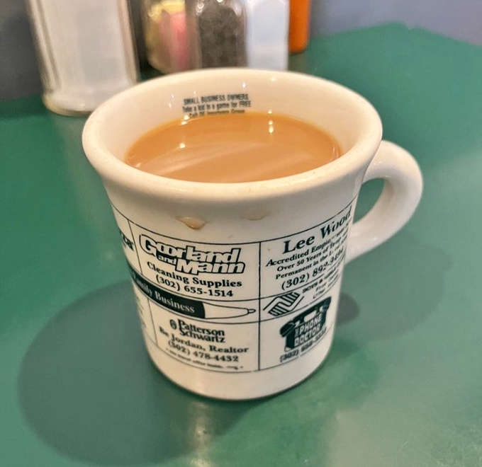 The coffee comes in mugs advertising local businesses&mdash;because in a place this authentic, even the cups tell stories about the community.