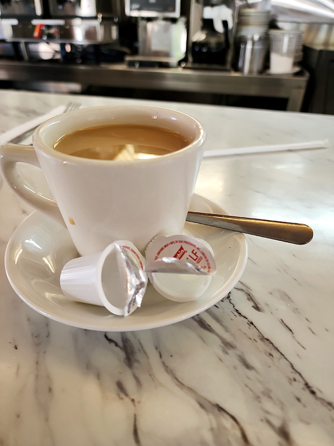 Coffee served in the only acceptable diner vessel—a thick white mug that keeps your brew hot while you contemplate ordering that second slice of pie.