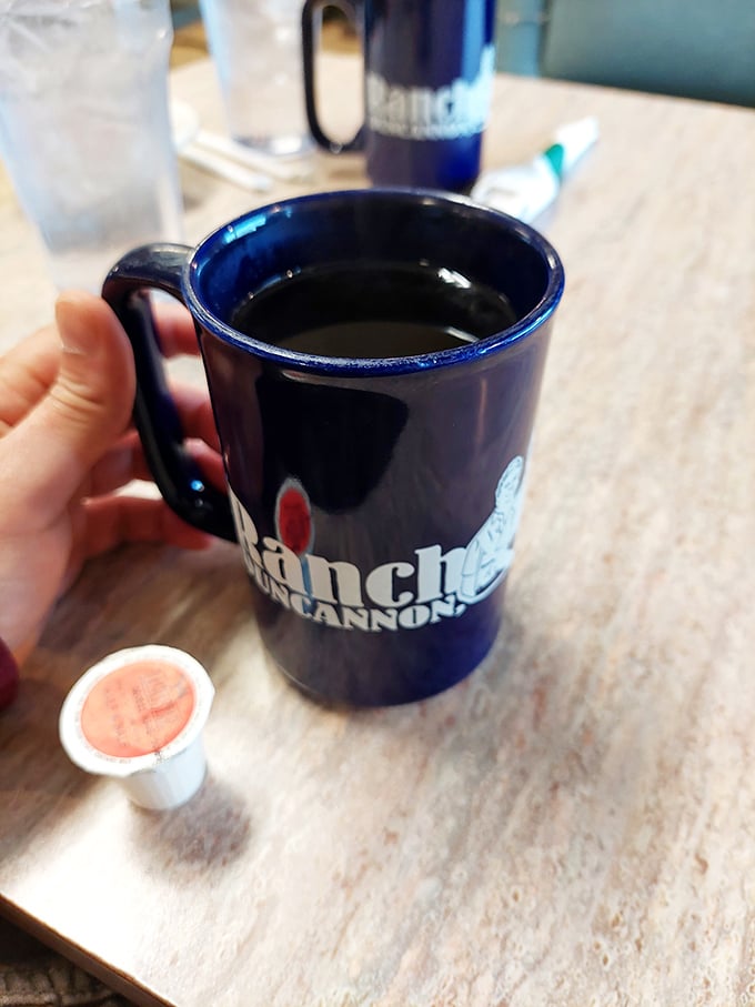 That deep blue mug isn't just holding coffee; it's holding the promise of a day that might actually turn out okay after all.